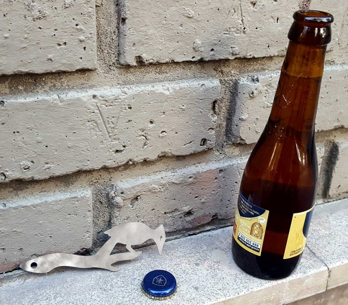 Original beer bottle opener decorated with a fancy bird.